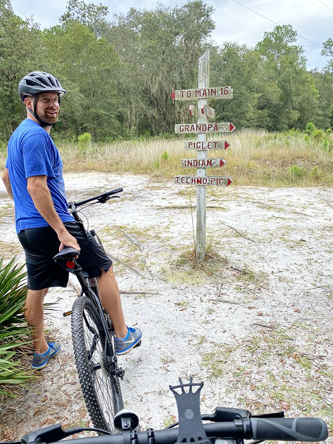 "To Piglet or Techno Pig?" That's the question facing our cycling friend at this whimsical trail marker crossroads.