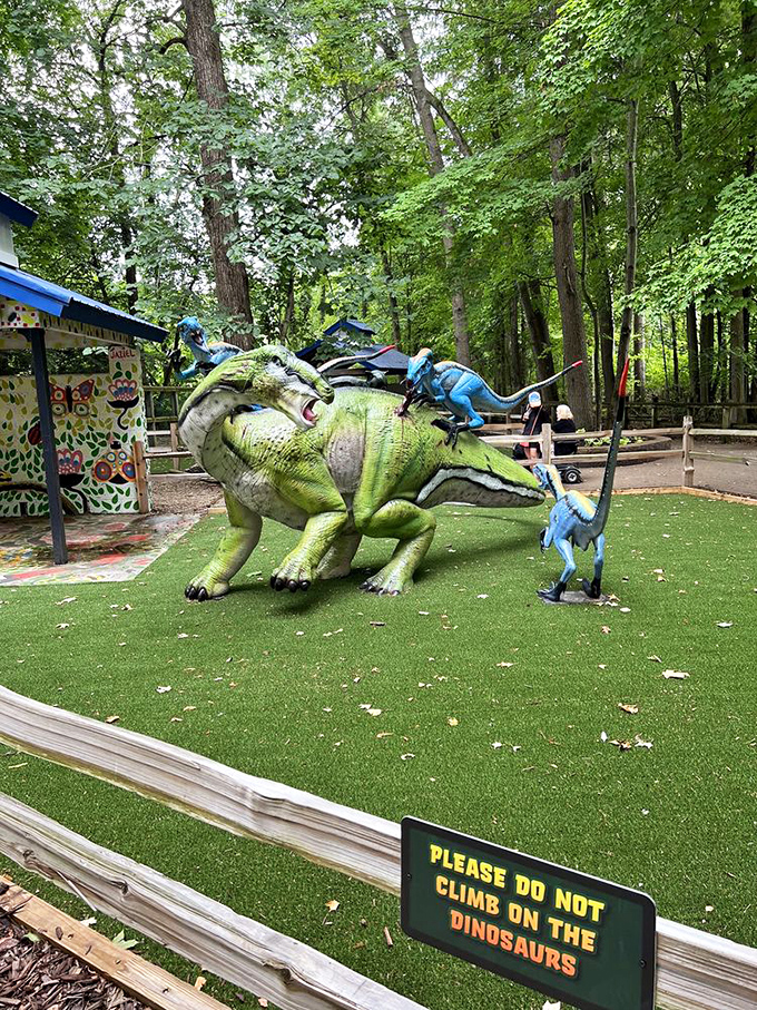 Dinosaur sculptures provide prehistoric thrills without the running-for-your-life part, though the "no climbing" sign suggests some visitors need reminding.