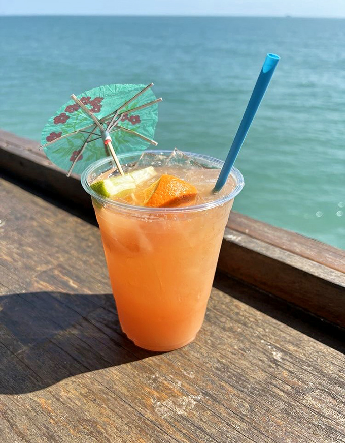 This isn't just a cocktail; it's a sunset in a glass, complete with tiny umbrella that somehow makes everything taste 30% more tropical.