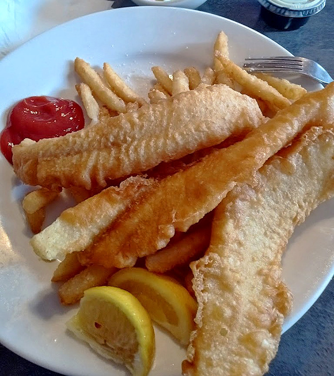Golden planks of fish that would make Neptune himself jealous, accompanied by fries that understand their supporting role in this seafood symphony.