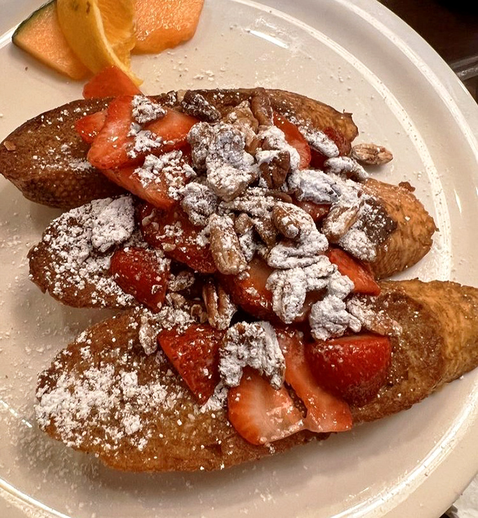 French toast elevated to art form&mdash;crispy edges, custardy centers, and fresh strawberries create breakfast worth celebrating.