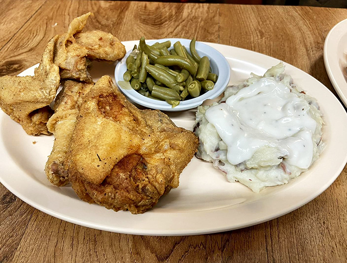 Crispy, golden-brown chicken shares the spotlight with creamy mashed potatoes and fresh green beans. Southern comfort on a plate, no passport required.