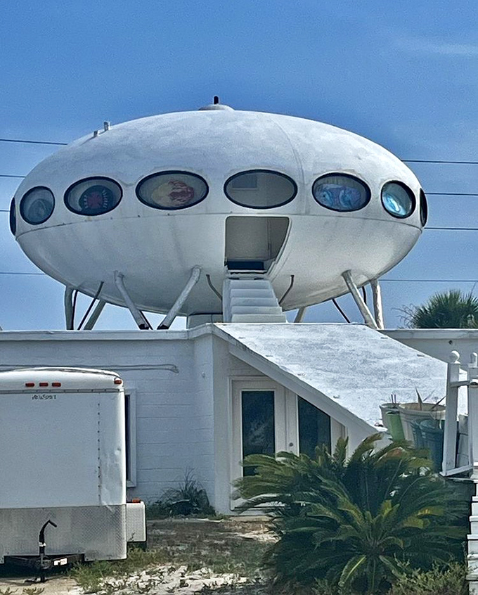 The white staircase beckons skyward, leading to a perfectly preserved piece of Space Age optimism amid Florida's natural beauty.