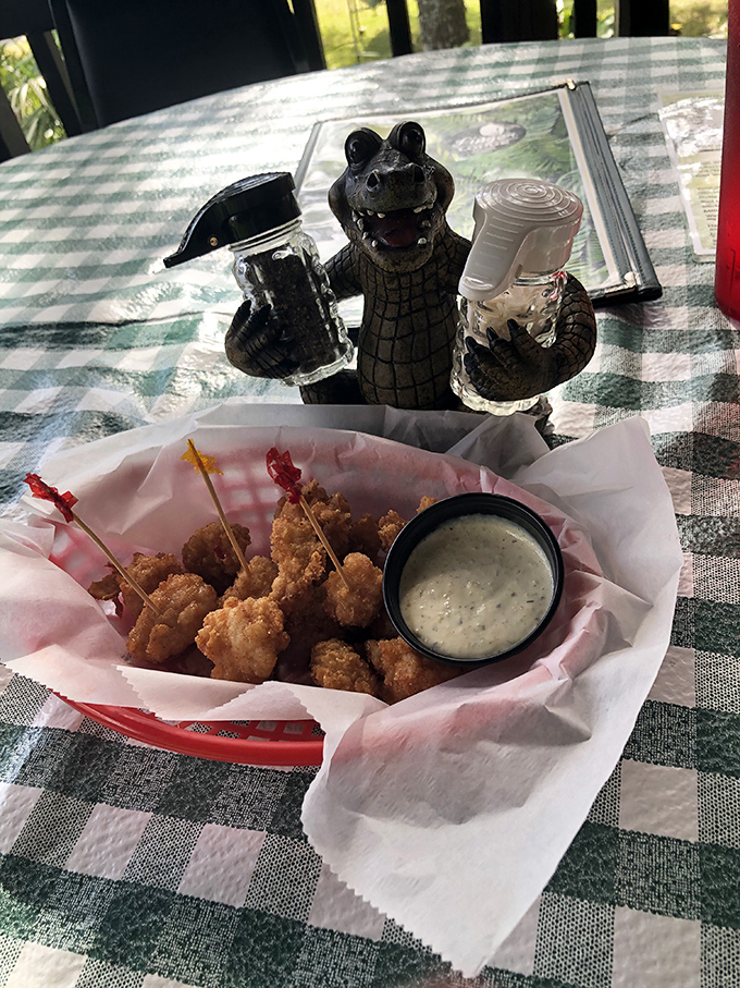 Gator Bites: Florida's favorite reptile makes a delicious appearance as golden-fried nuggets, served with a smile from their alligator condiment-holding cousin.