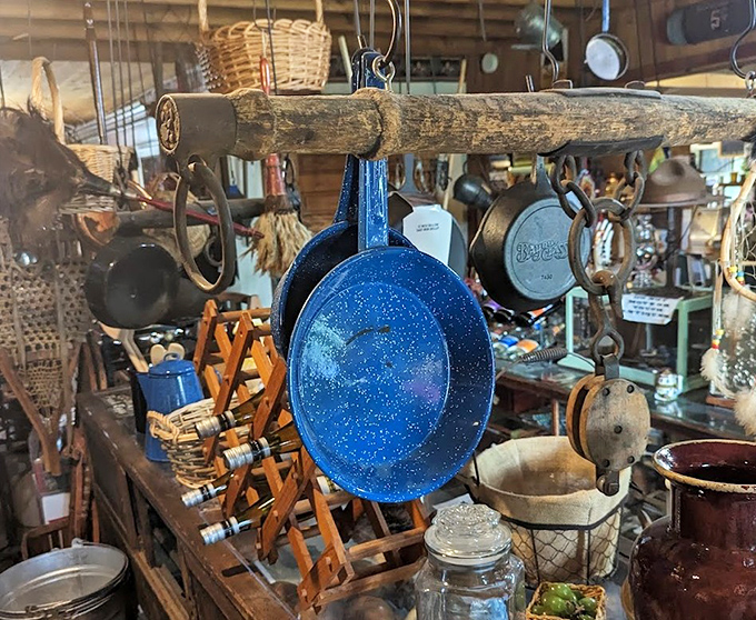 Overhead, a practical gallery of American kitchenware dangles from rough-hewn beams &ndash; each pot and pan with stories seasoned into its surface.
