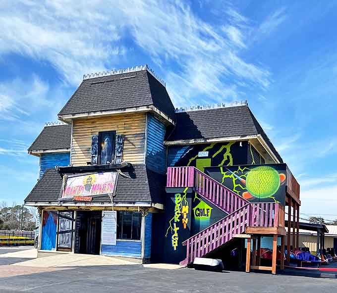 The weathered blue haunted house looks like it was plucked from a Stephen King novel and plopped down between the cotton candy stand and go-karts.