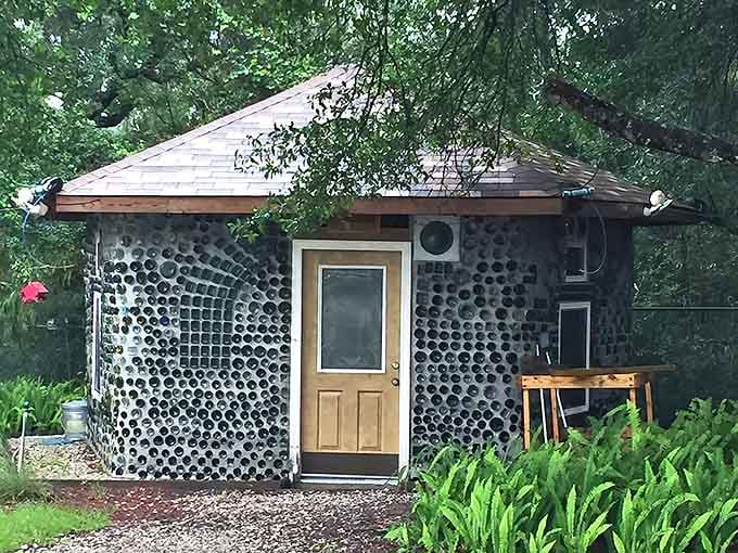 The bottle house itself resembles a hobbit home that took a detour through a recycling center, emerging as something magical.