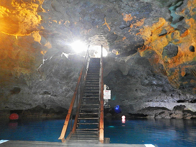 Interior Cavern Staircase View: Metal stairs disappear into electric-blue waters, like the stairway to an aquatic heaven that welcomes all brave souls.