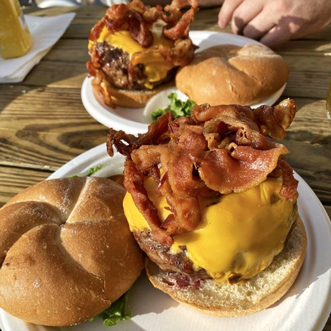 Meet Le Burger's bacon-topped cousin – where crispy, smoky strips crown the already magnificent meat mountain like a pork tiara.