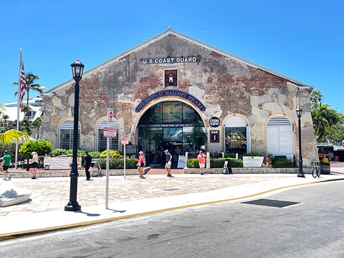 The weathered facade of the old Coast Guard building tells tales of maritime history as tourists explore Mallory Square.