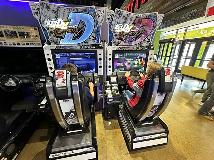 These Initial D racing cabinets transform ordinary folks into drift kings, letting you experience Tokyo highways without the pesky speeding tickets.