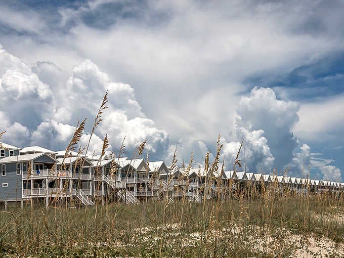 Beach houses line the shore like a colorful parade, offering front-row seats to nature's greatest show: the ever-changing Gulf of Mexico.