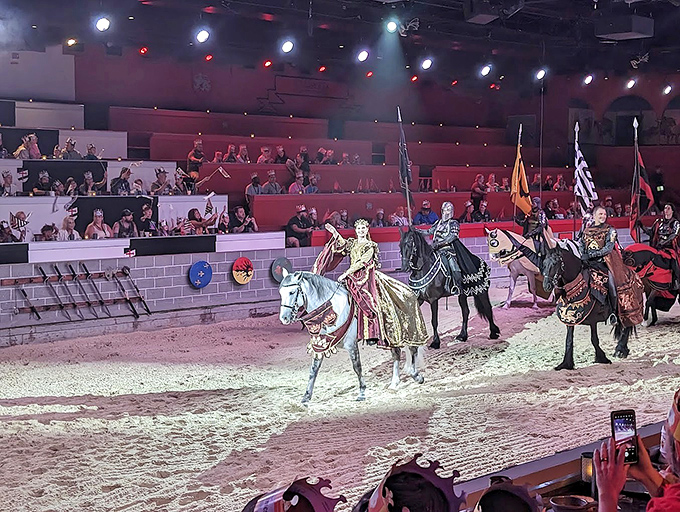 Royal Court Procession: The royal court processes with regal bearing, their colorful attire a stark contrast to the arena's earthy tones.