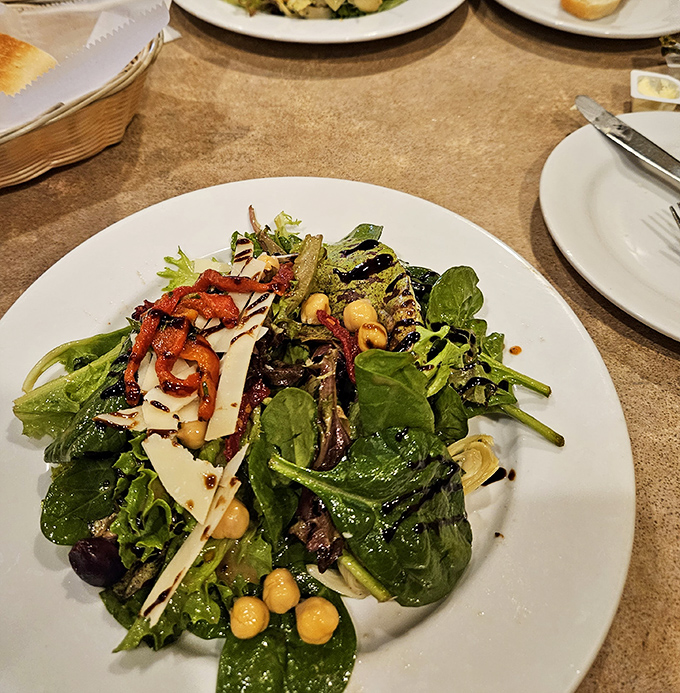 A salad that actually excites &ndash; crisp greens, chickpeas, and shaved Parmigiano drizzled with balsamic that's actually aged, not just colored.
