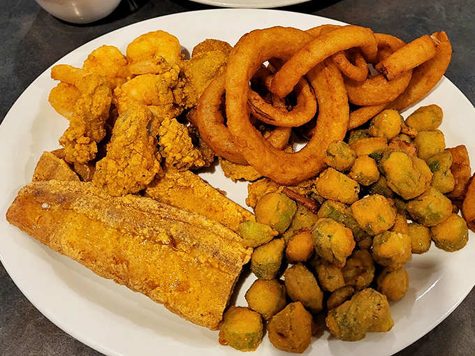 The holy trinity of Southern seafood &ndash; golden fried shrimp, fish, and hush puppies &ndash; arranged with the reverence they deserve.