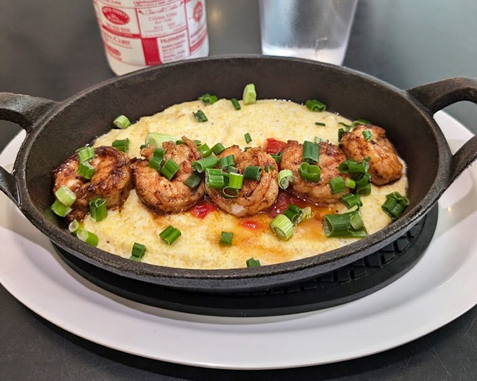 Shrimp and grits that would make a Southerner weep with joy – plump shrimp nestled on creamy grits with a scatter of green onions.