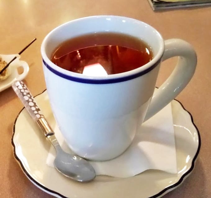 Proper tea served in a proper cup with saucer &ndash; a civilized nod to the band's British roots amid American coffee culture.