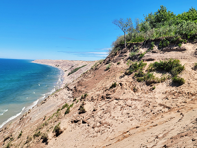 This sweeping shoreline view showcases the dramatic meeting of sand and water, where Lake Superior stretches toward the horizon like an inland ocean.