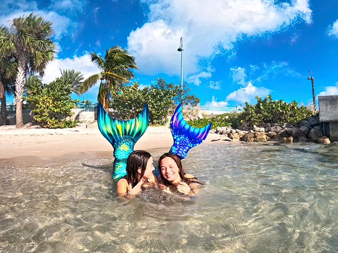 Mother and daughter mermaid moment in shallow waters &ndash; proving magical transformations are best when shared with family.