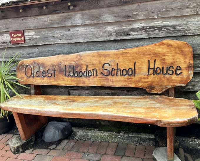 Wooden Bench Memorial: "Oldest Wooden School House" carved into this rustic bench invites visitors to sit and contemplate education through the centuries.