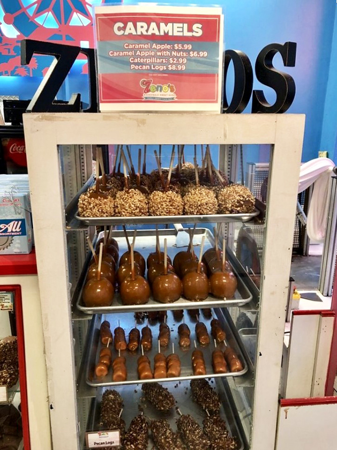 Caramel apples standing at attention like sugary soldiers, each one a masterpiece of sweet engineering.