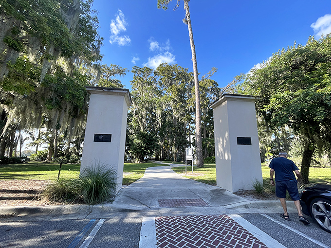 White pillars frame the garden entrance, standing like sentinels guarding this slice of paradise from the outside world.