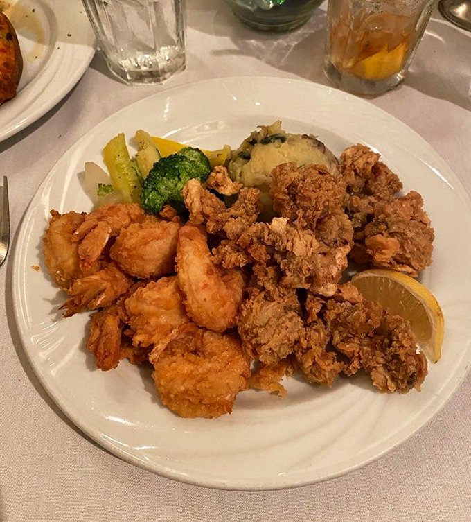 The ultimate Florida feast &ndash; golden fried oysters and succulent shrimp share the spotlight with fresh vegetables. A plate that captures the essence of coastal dining.
