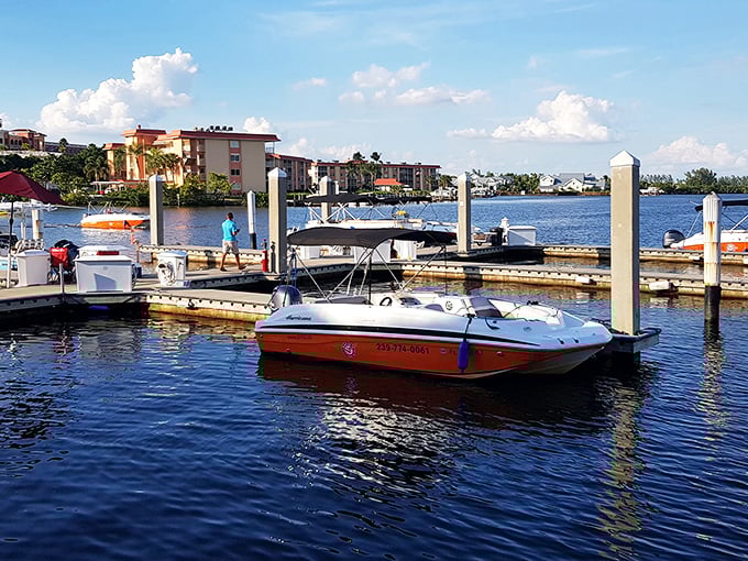 Boats gently bob in the harbor as a visitor strolls along the dock &ndash; just another perfect day in Naples' picturesque waterfront district.