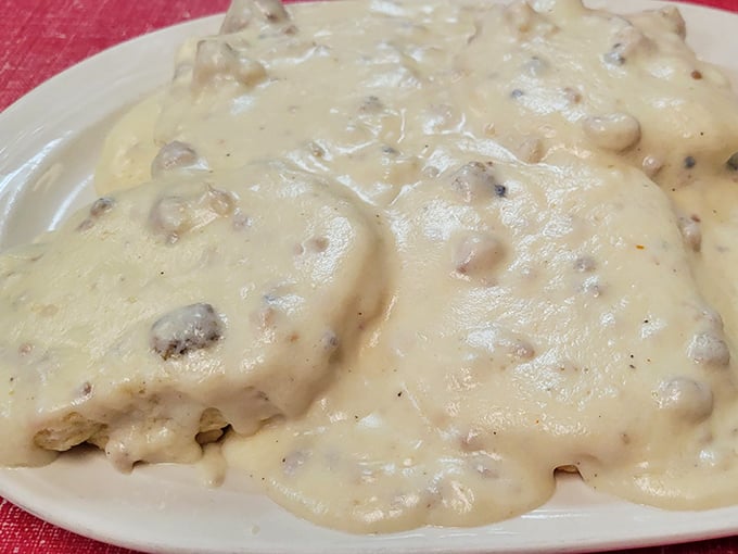 A masterclass in comfort food engineering—layers of biscuit, meat, and that legendary gravy creating the ultimate breakfast symphony.
