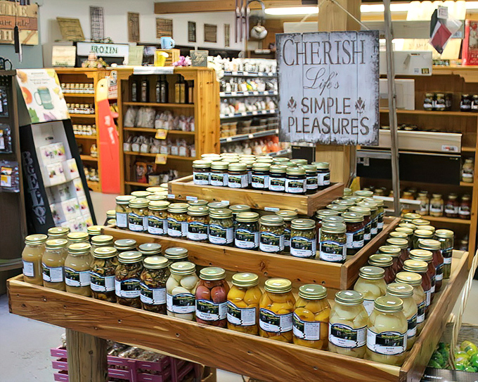 Mason jars stacked in wooden crates create an edible color wheel of preserved summer, each one a time capsule of flavor.