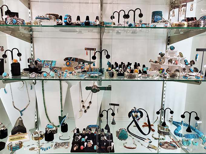 Turquoise jewelry gleams under display lights, each piece whispering tales of the Southwest and the artisans who shaped earth's treasures.