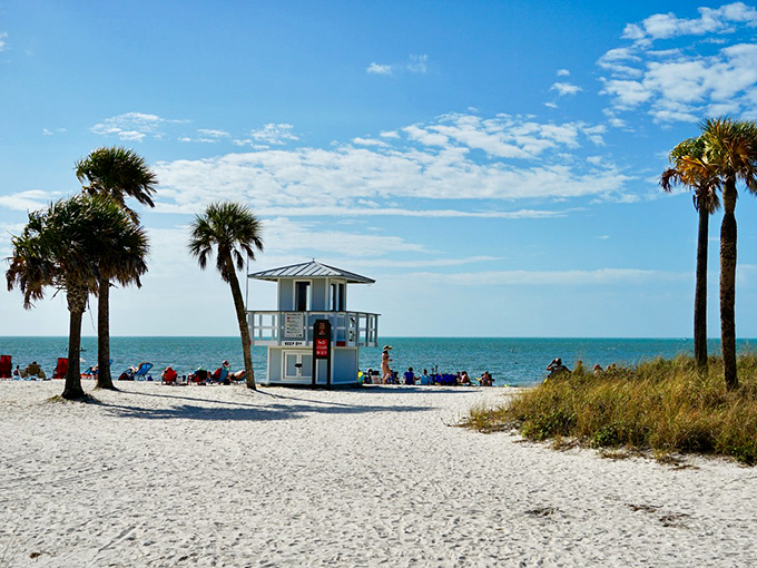 A classic Florida beach scene: powdery sand, crystal waters, and a lifeguard stand straight from a postcard.