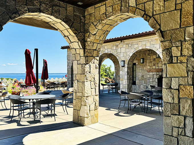 Stone arches frame the perfect Michigan afternoon &ndash; Mari's outdoor seating area blends Mediterranean architecture with pure Northern Michigan beauty.