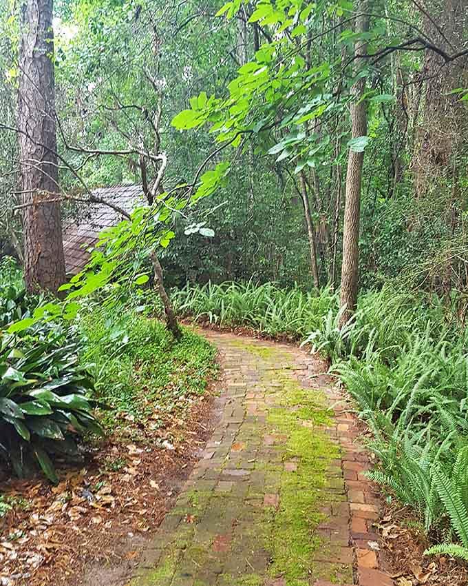 The path less traveled: Brick walkways lined with ferns and native plants lead visitors through Lichgate's enchanted landscape.