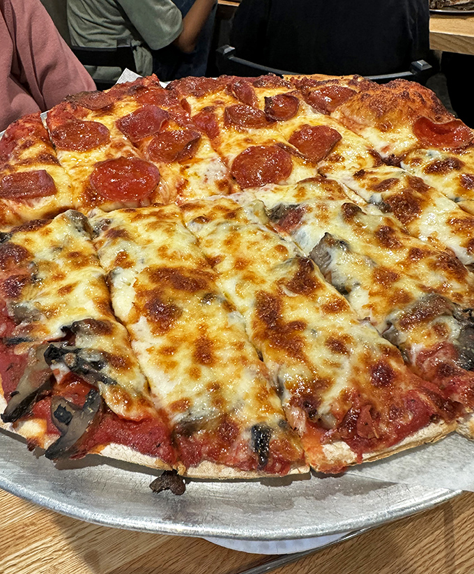 Pizza: Cheese bubbling in golden pools across a landscape of perfect crust &ndash; half pepperoni, half mushroom, but 100% delicious no matter how you slice it.