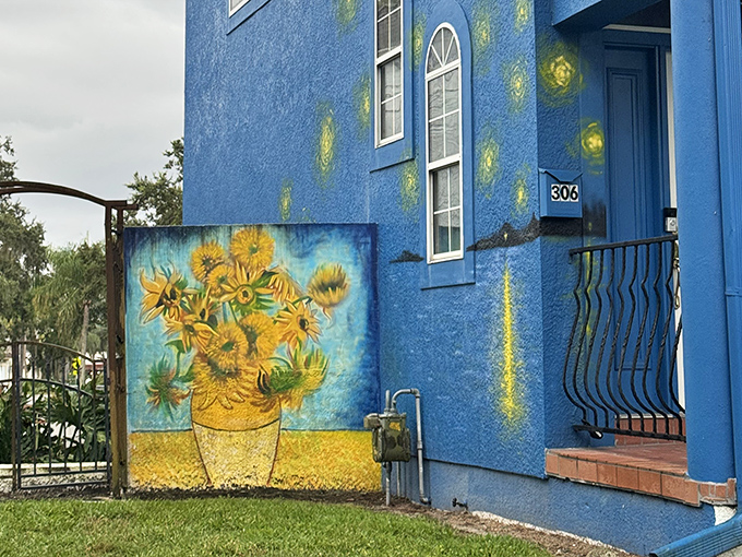 The iconic sunflowers burst with vibrant energy against the blue backdrop, capturing van Gogh's love affair with these cheerful blooms.