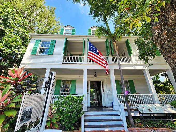 The white colonial house with green shutters offers a cool retreat from the Key West heat.