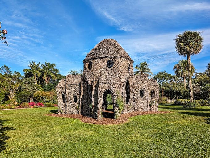 This whimsical woven structure looks like something hobbits might build for a tropical vacation, complete with palm tree neighbors.