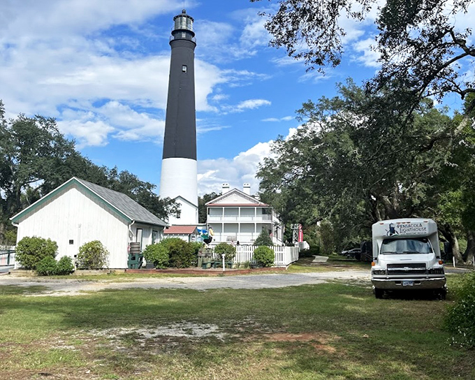 Pensacola's striking black and white lighthouse towers against a brilliant blue sky, its bold contrast design a navigational landmark for generations.