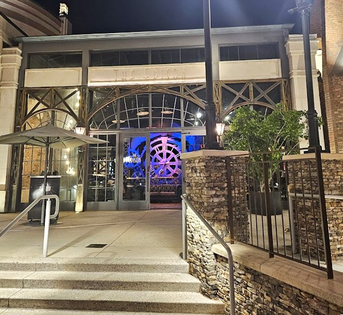 Vintage-inspired architecture with modern touches creates an inviting entrance to this unique dining spot. The Edison's nighttime lighting transforms it into a glowing beacon.