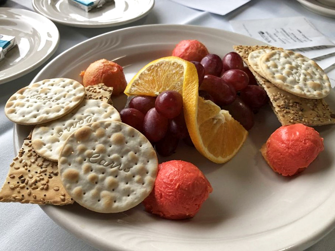 An artful arrangement of crackers, cheese, and fruit starts your evening of detection &ndash; notice how the grapes cluster like clues waiting to be connected.