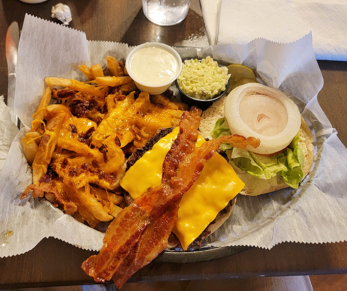 A burger that requires a game plan and possibly a nap afterward, paired with fries that redefine the concept of "cheesy."
