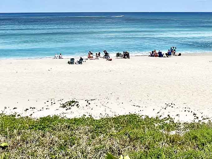 Beach-goers space themselves like punctuation marks on this sandy sentence of shoreline, each enjoying their own chapter of relaxation.