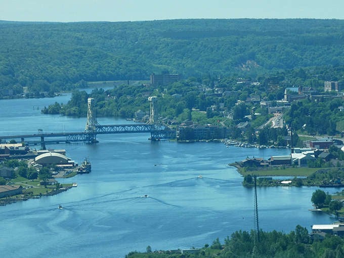 That lift bridge is the area's way of saying hello to ships and goodbye to traffic, a mechanical marvel that still does its job after all these years.