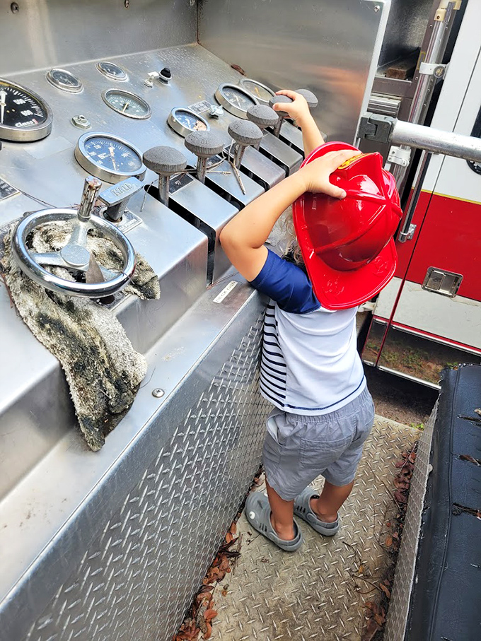 Future firefighter in training! The interactive exhibits let kids experience the thrill of operating equipment without the actual flames.