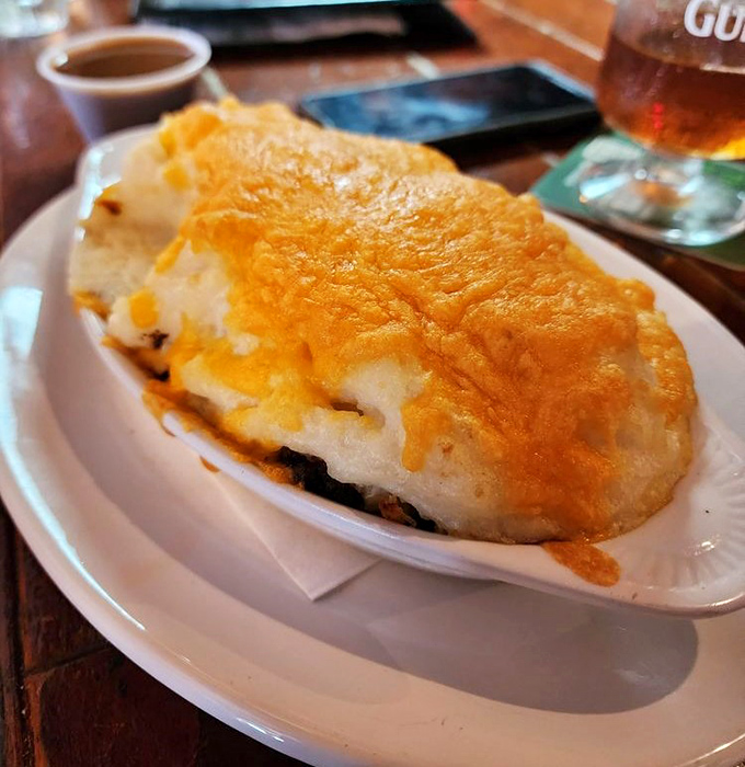 Comfort food royalty &ndash; a bubbling crown of cheese-topped mashed potatoes guarding savory treasures beneath.