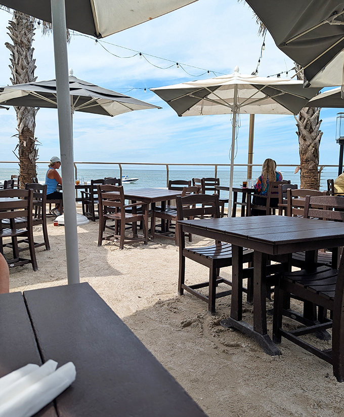 Dining with a view: Wooden tables and chairs planted right in the sand create the ultimate "yes, I'm really here" moment.