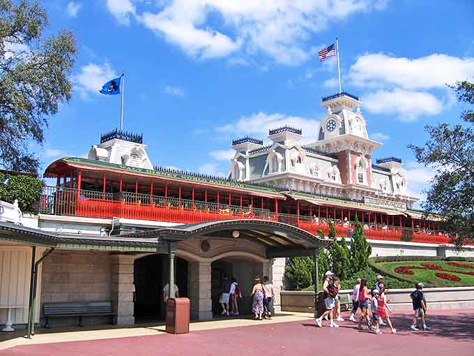 Magic Kingdom's iconic entrance welcomes visitors, with the railroad station serving as both functional transportation hub and architectural masterpiece.