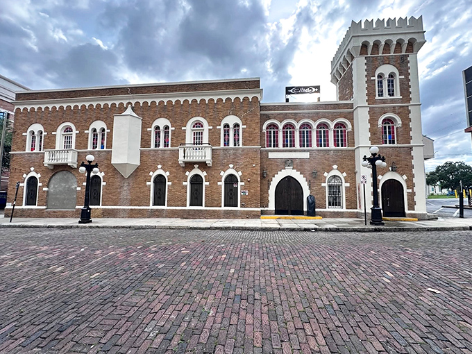 Daylight reveals The Castle's architectural details &ndash; ornate stonework, arched windows, and medieval-inspired tower &ndash; standing proudly on cobblestone streets in historic Ybor City.