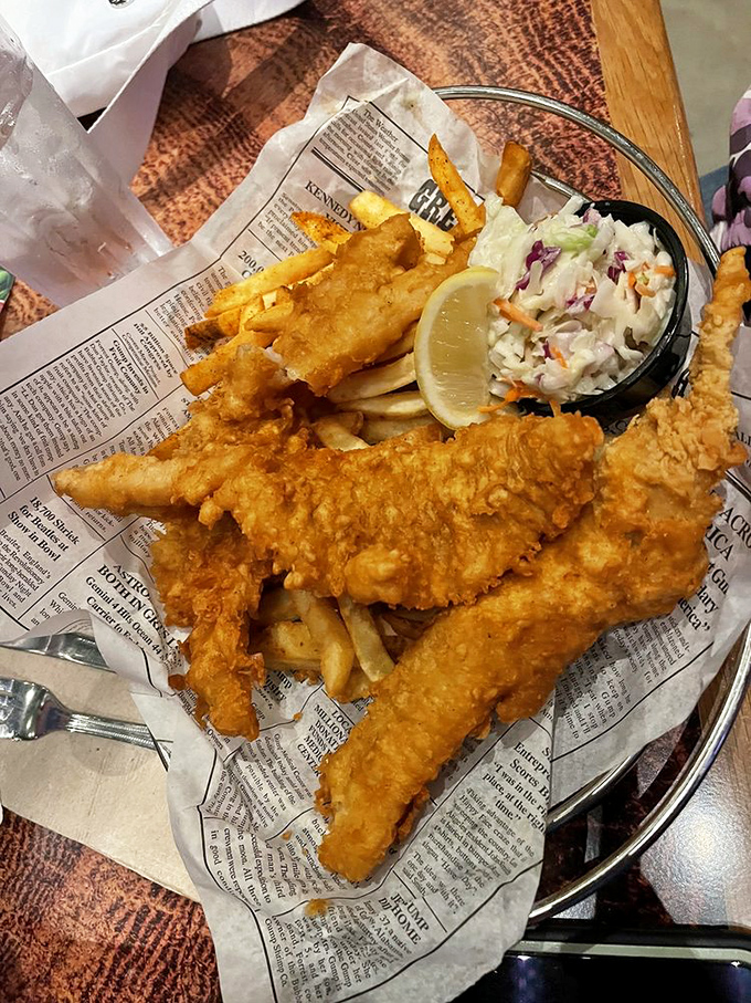 Classic fish and chips served on mock newspaper &ndash; crispy, golden comfort food that would make any British explorer feel right at home in the jungle.
